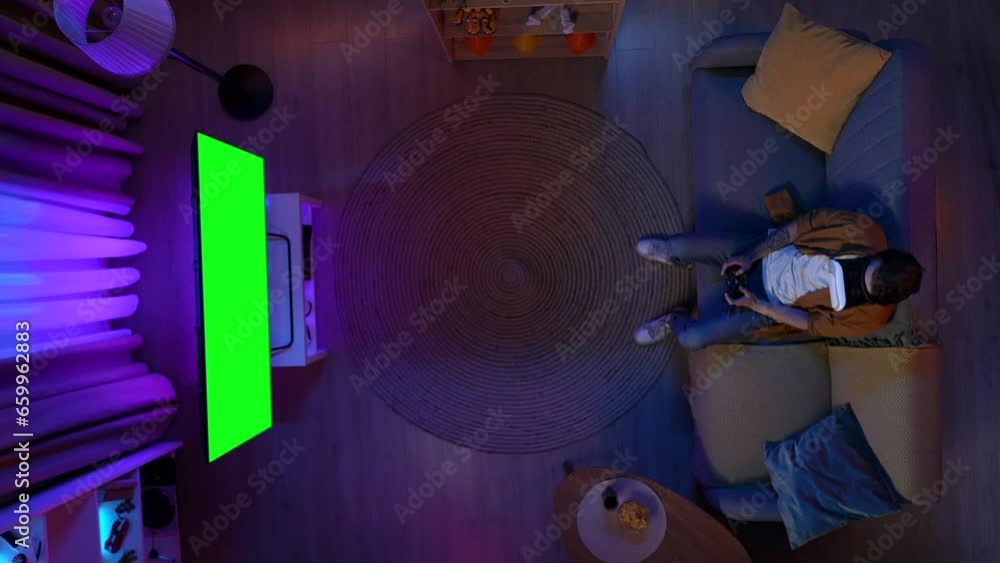Top view man in VR glasses playing game on TV with Chroma key green ...