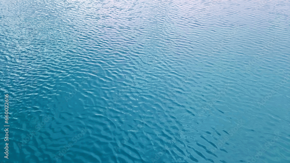 lake water background. gentle waves in light blue color tone. blue lake ...