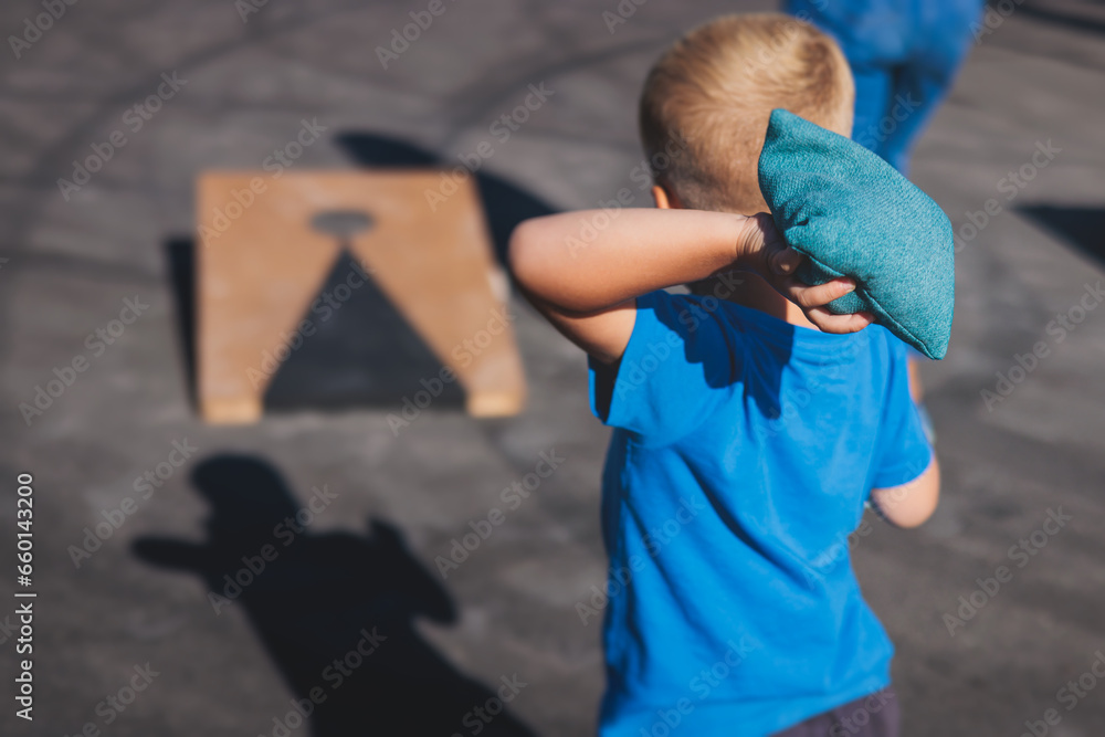 Cornhole game set, process of throwing bean bags, kids children tossing ...