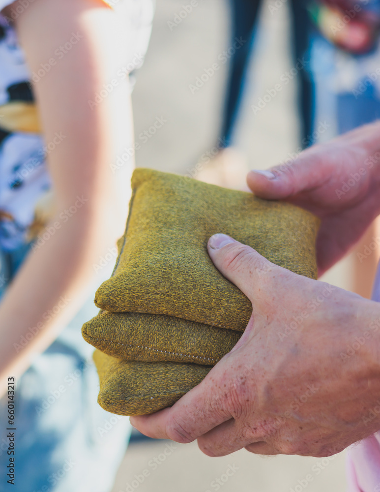 Cornhole game set, process of throwing bean bags, kids children tossing ...