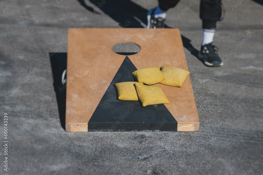 Cornhole game set, process of throwing bean bags, kids children tossing ...