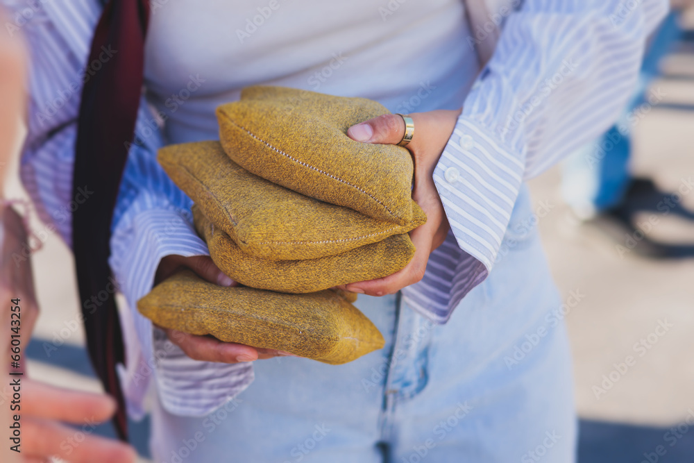 Cornhole game set, process of throwing bean bags, kids children tossing ...