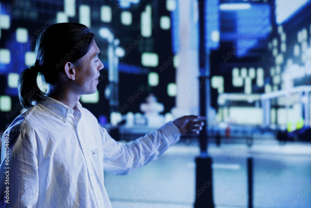 Relaxed asian man wandering around city streets at night, looking ...