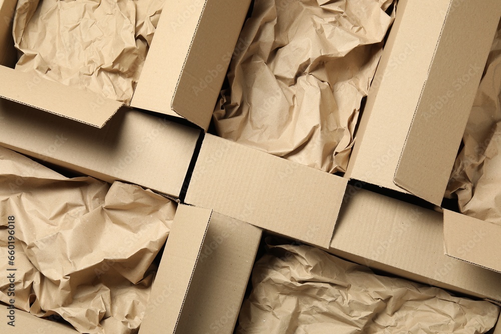 Open cardboard boxes with crumpled paper, top view. Packaging goods ...