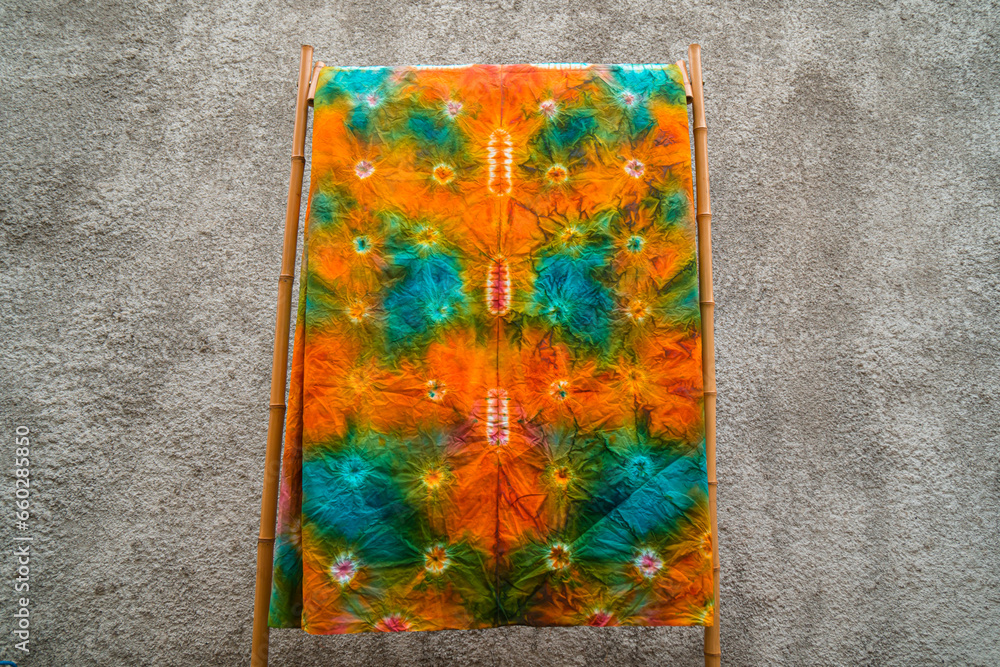 Traditional Javanese batik cloth with fine details hung on rattan ...