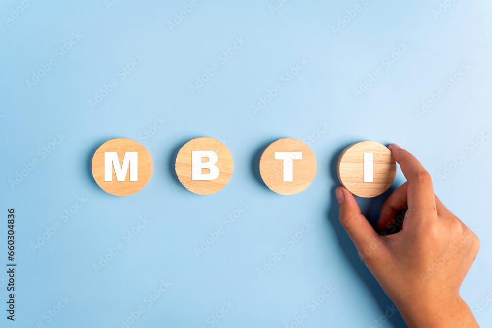Wooden blocks with the letters MBTI on blue background. Personality ...