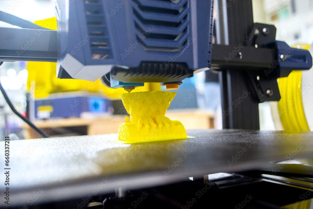 3D printer printing prototype from molten plastic. Process of creating ...