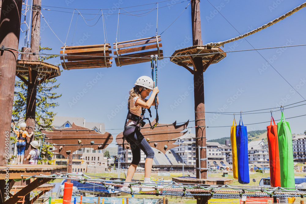 Brave child challenges in adventure park at forest, obstacle course ...