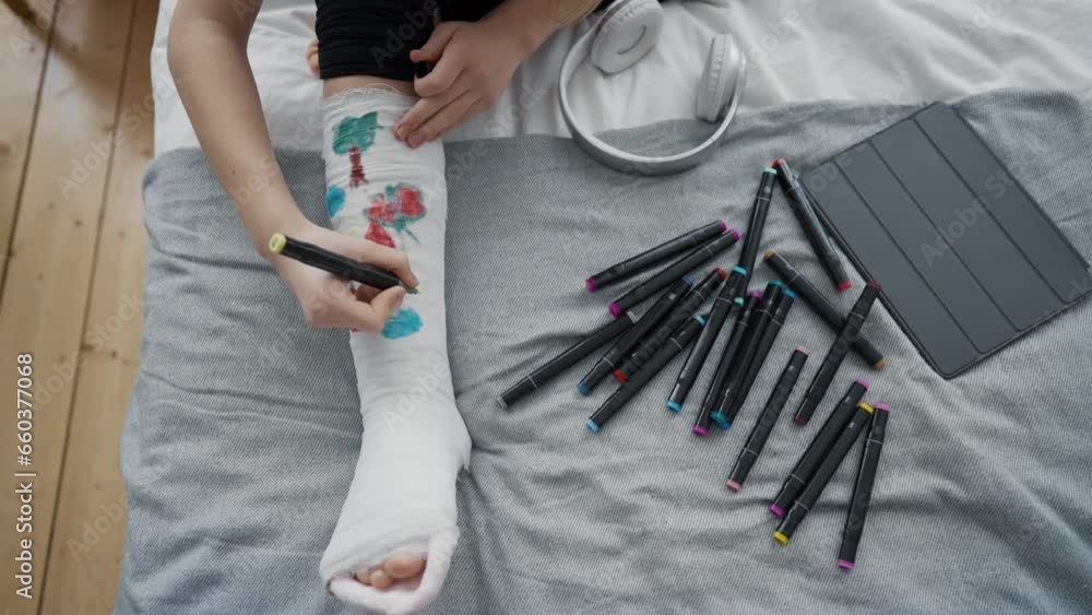 Hands teenage girl with broken leg in orthopedic cast painting pictures ...