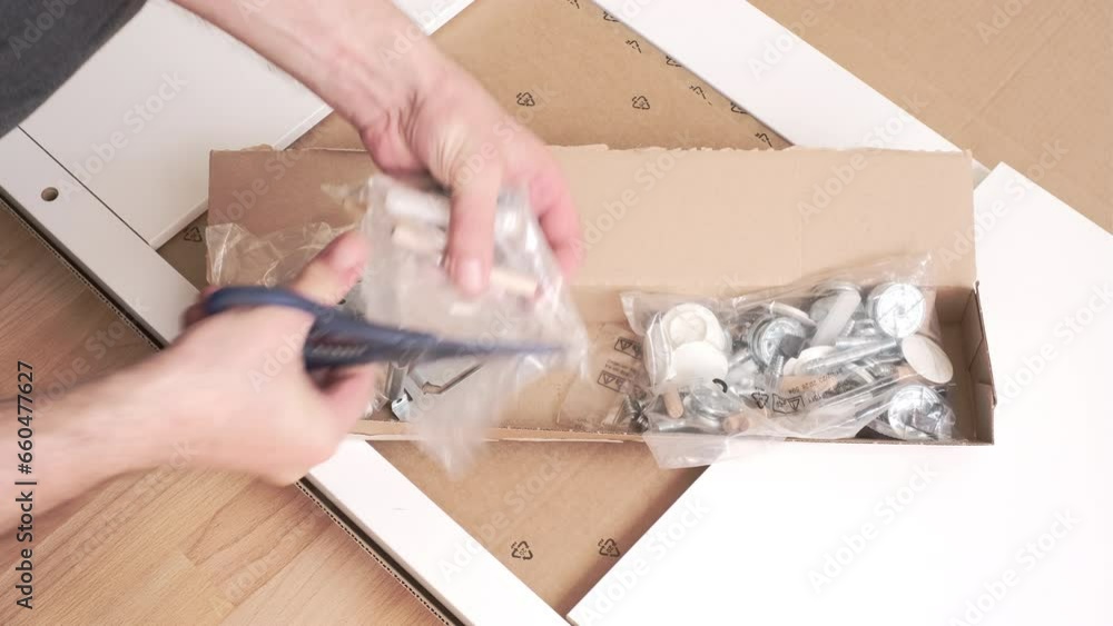 Assembling a New bed in the Bedroom. Man install the bed frame to ...