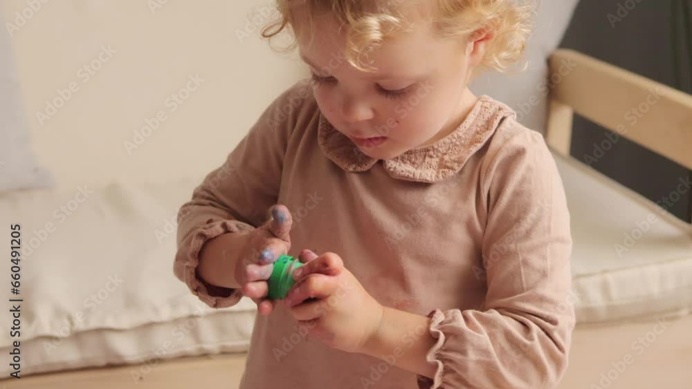 Creative little artist. Adorable baby drawing. Funny curly haired ...