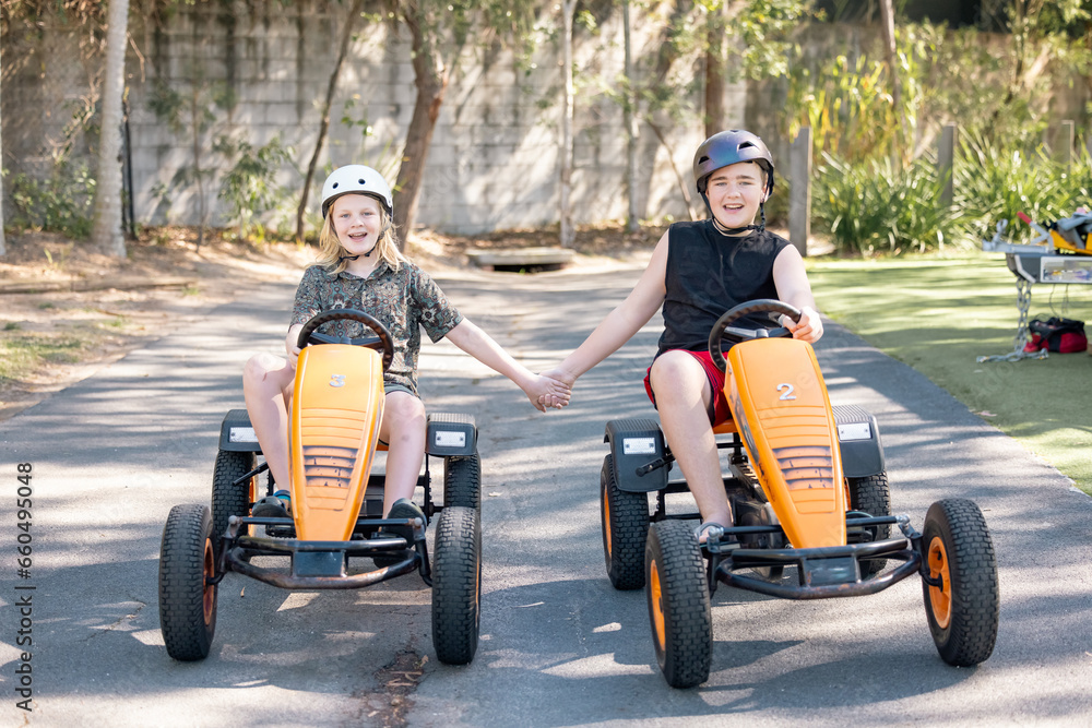 Kids riding pedal carts on family holiday at caravan park Stock Photo ...