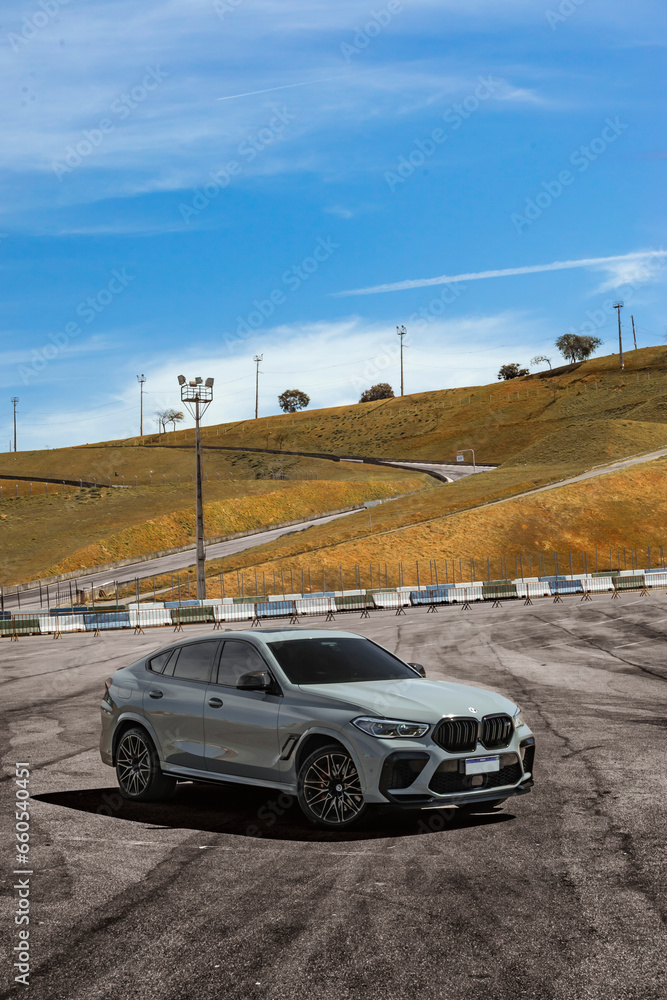 Grey BMW X6 M Competition front view three quarters, race track ...