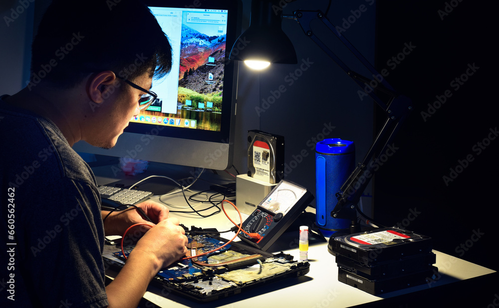 computer technician Motherboard repairman wearing glasses is using an ...