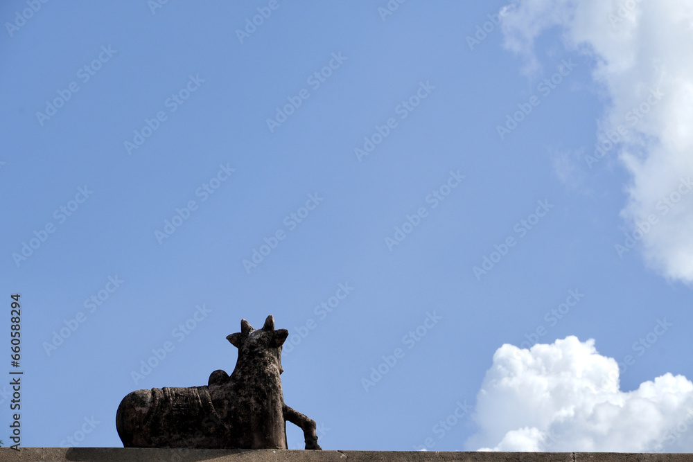 Sacred Cow statue in Hindu temple wall. Holy Nandi animal sculpture in ...