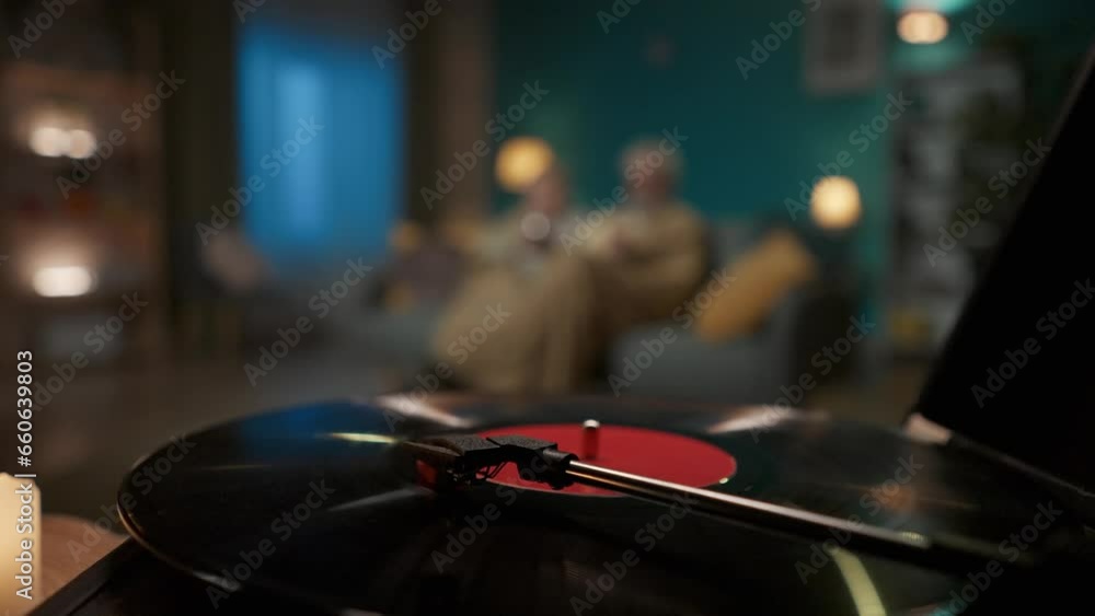 Close up shot shows a vinyl turntable spinning a record. The camera ...
