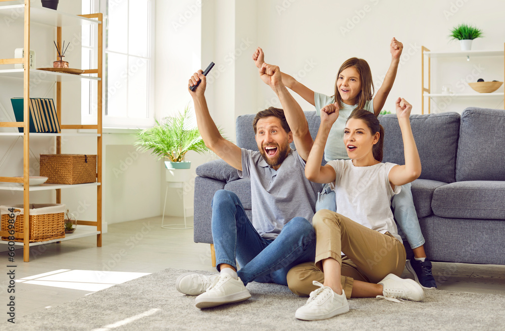 Family of three watching TV together. Family spending weekend at home ...