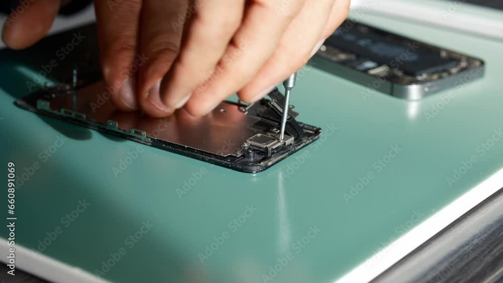 Close-up shot showing the process of cell phone repairing. Technician ...