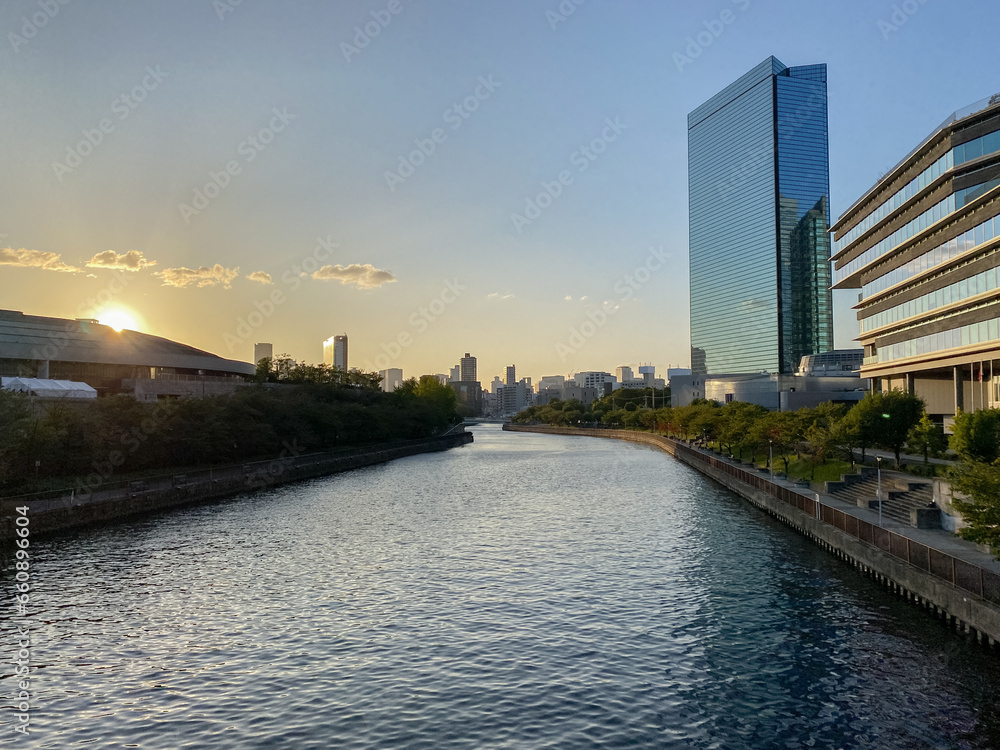 Watefront promenade with river bench in Japanese city of Osaka with ...