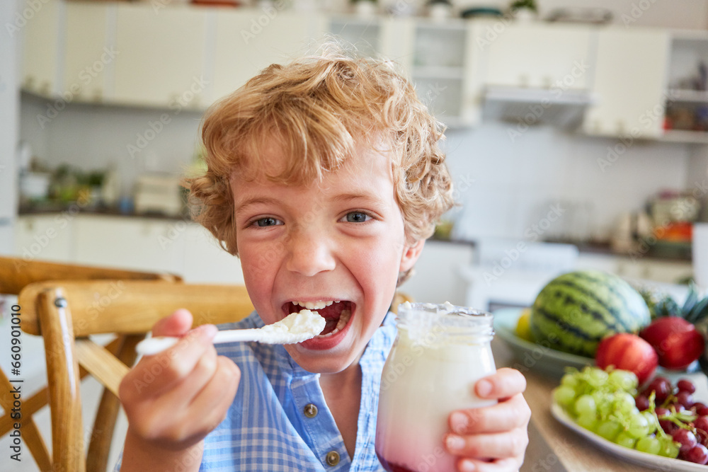 Cheerful boy eating parfait at home Stock Photo | Adobe Stock