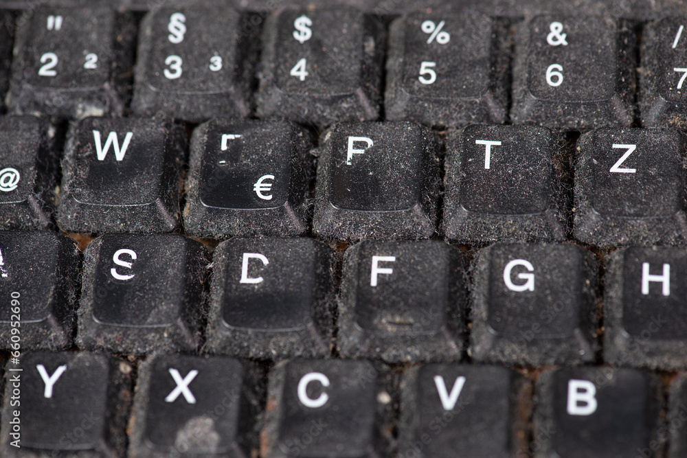 Filthy and dusty computer keyboard on an office desk, dirty electronic ...