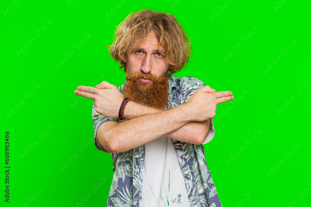 Young bearded man pointing around with finger gun gesture, looking ...