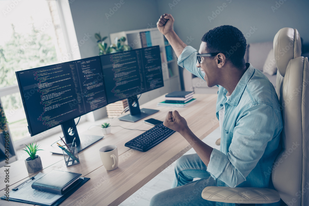 Side shot of crazy young guy celebrating his code works without bugs he ...
