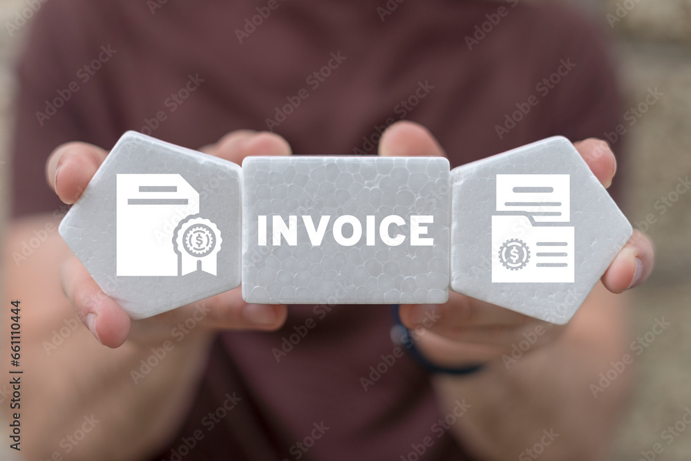 Man holding white foam blocks sees word: INVOICE. Concept of online ...