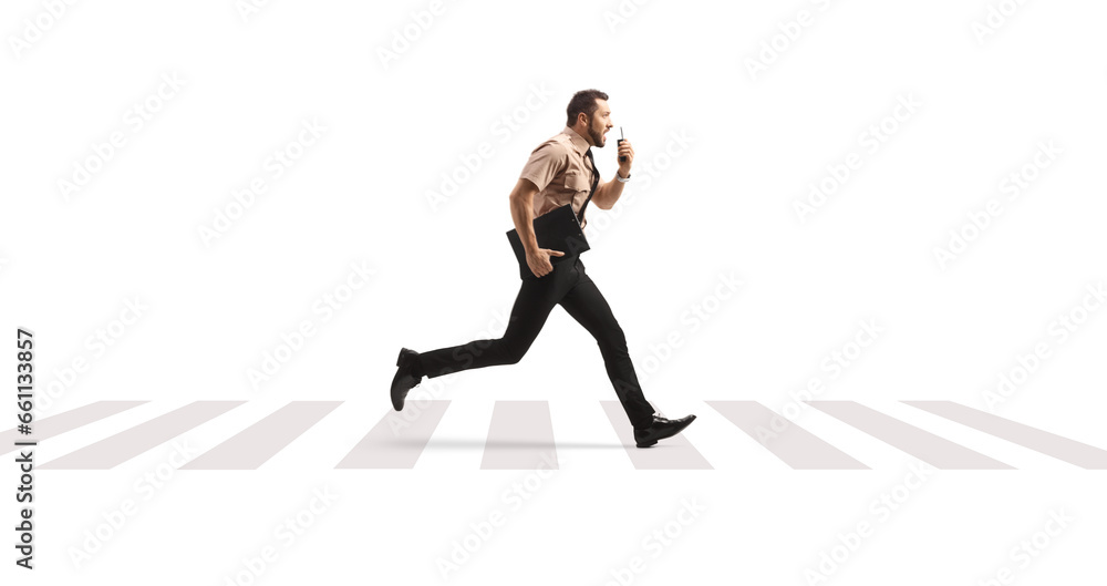 Full length profile shot of a security guard running at a pedestrian ...