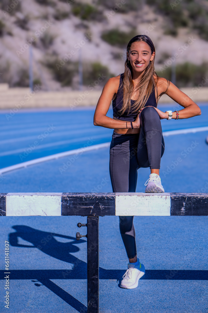Beautiful young runner girl, tanned with long brown hair, smiling with ...