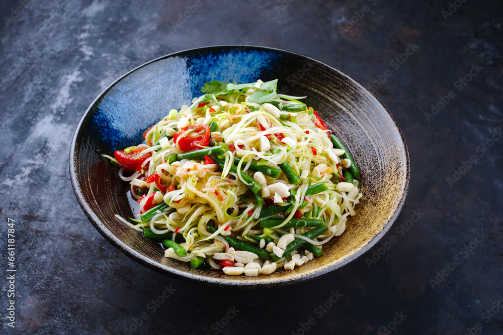 Traditional Thai green papaya som tam salad with green papaya slices ...