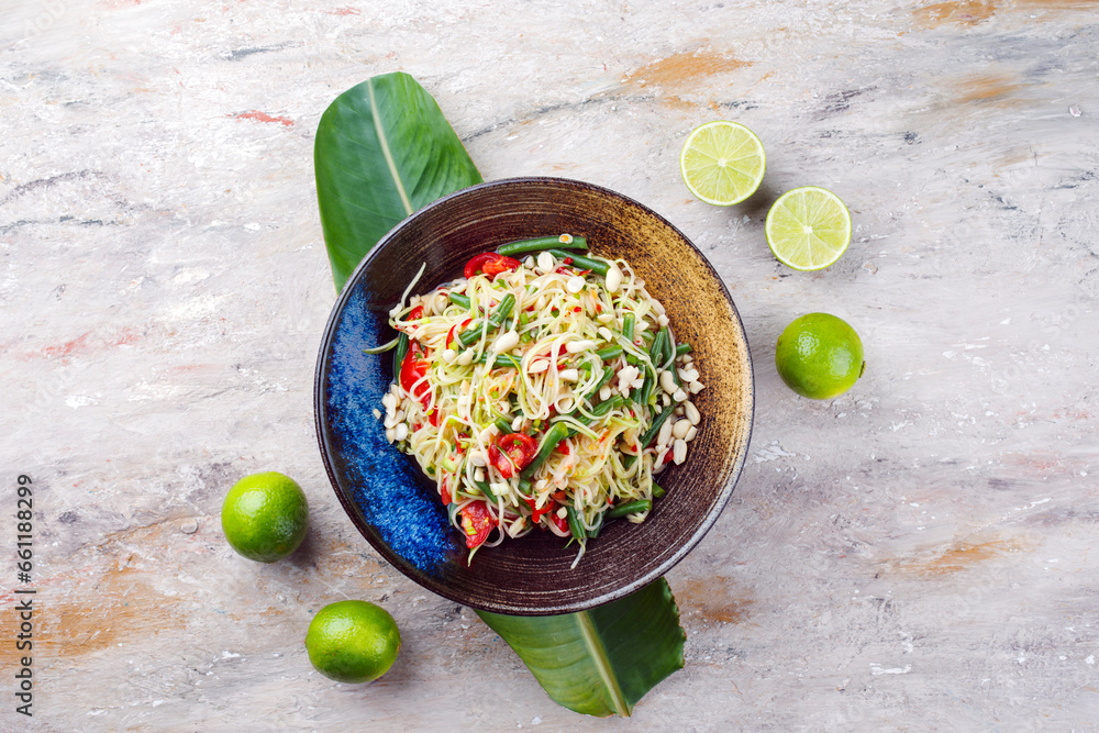 Traditional Thai green papaya som tam salad with green papaya slices ...