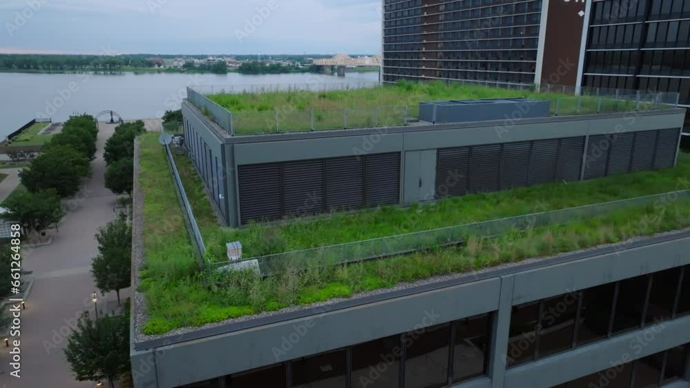 Green roof on city skyscraper with river in background. Eco friendly ...