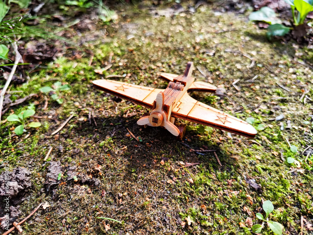 Vintage toy wooden airplane with stars on wing in nature. Plane crash ...