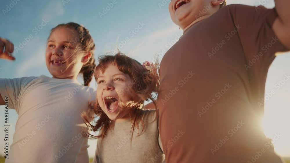 group of kids team hugging a jumping and rejoicing outdoors. happy ...