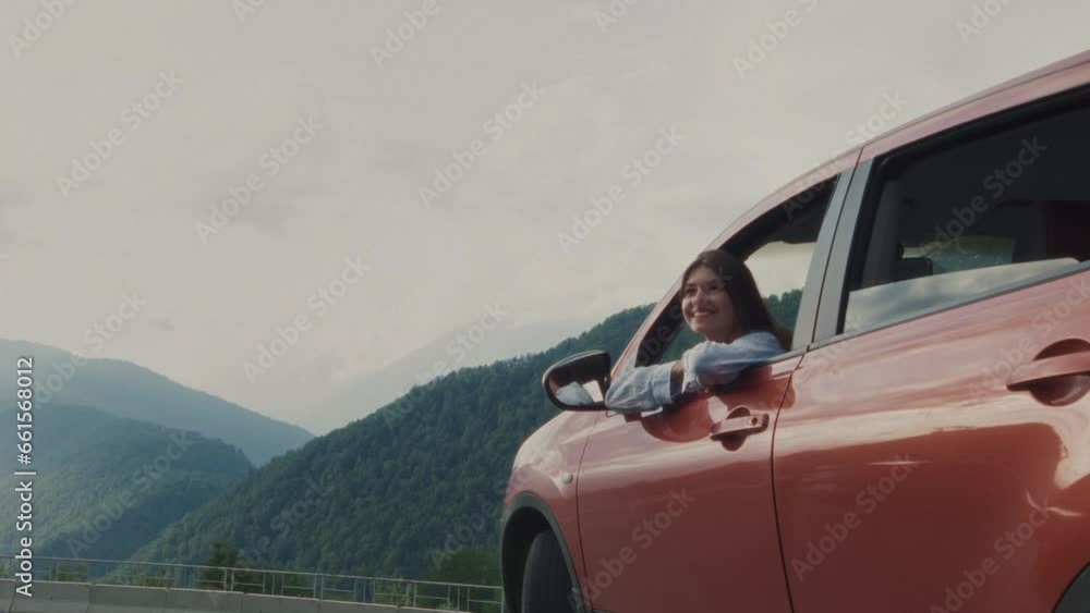 Pretty girl looks out the open car window, woman sitting in car with ...