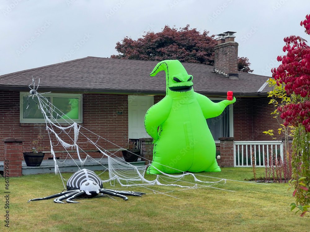 Inflatable figures of green Oogie Boogie and spider at web Stock Photo ...