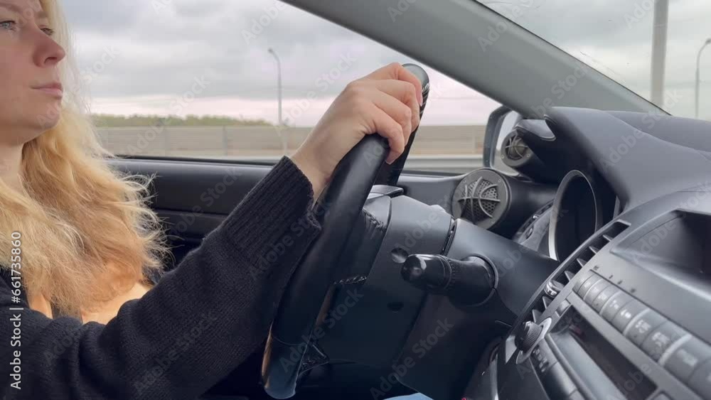 Driver behind the wheel, a person looking out at the city streets, a ...