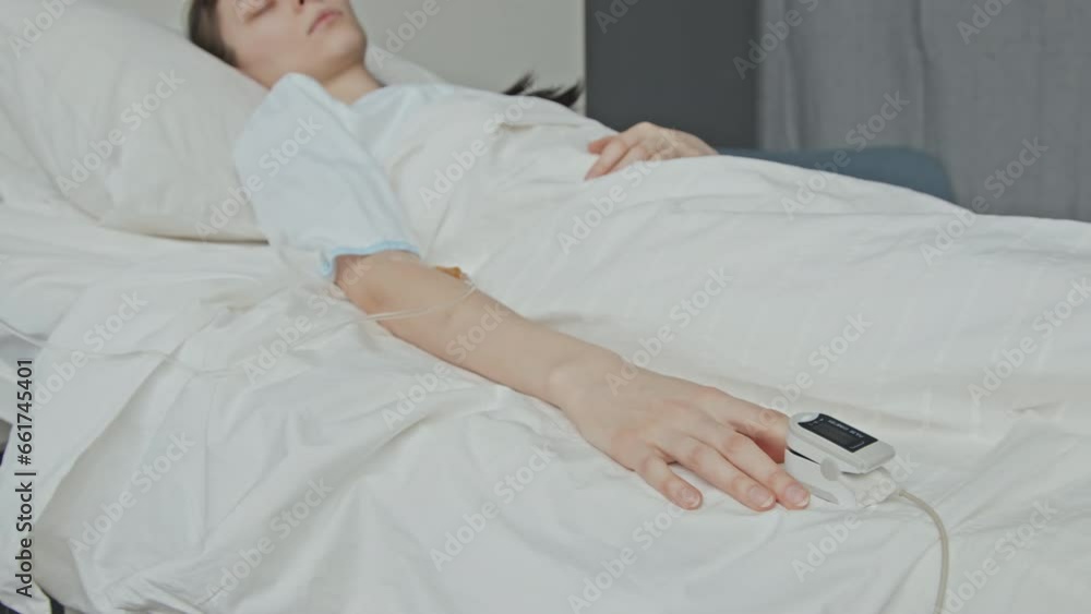 Selective focus panning shot of Caucasian female patient lying ...