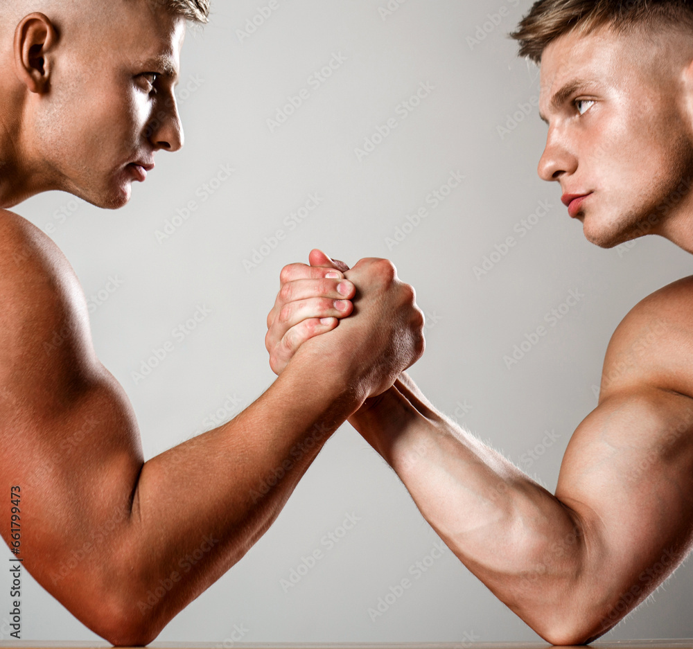 Muscular men measuring forces, arms. Hand wrestling, compete. Hands or ...