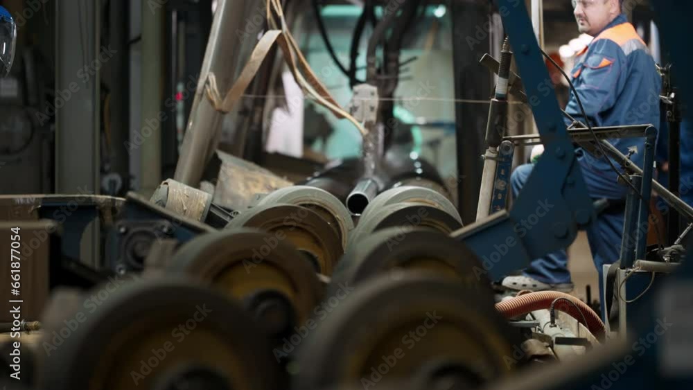 Video „Automatic conveyor equipment processing the metal pipe. Worker ...