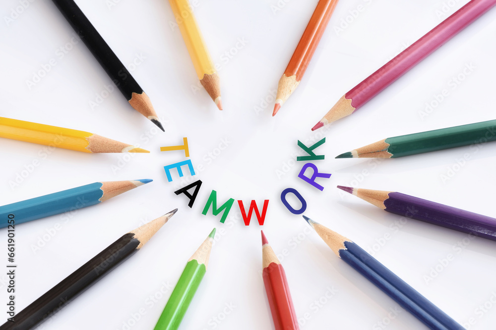 Teamwork written on paper with colored pencils isolated on white ...