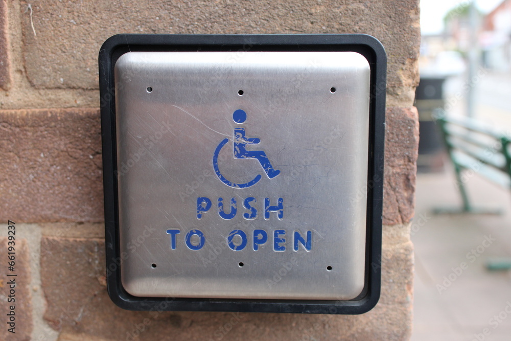 Disabled square door access button "Push to open" up close perspective ...