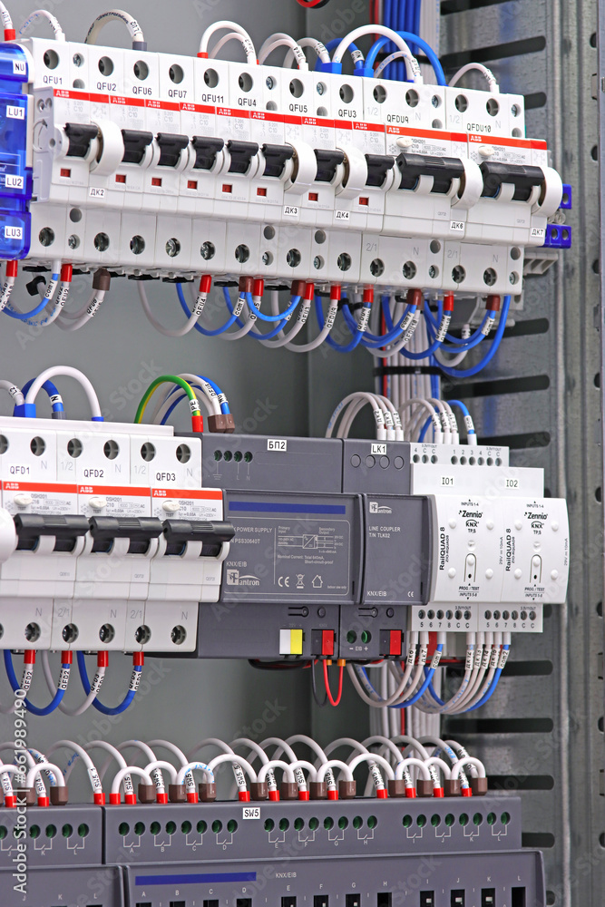 electric circuit breakers installed on a din rail in an electric ...