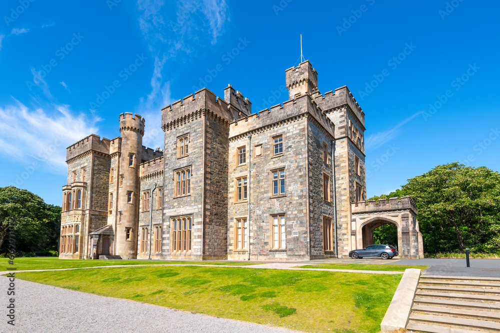 The historic Lews Castle looks out over the harbor port of the village ...