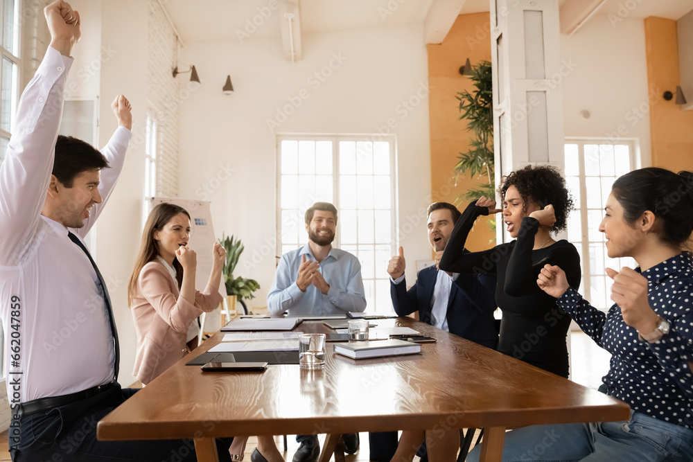 Happy excited diverse business coworkers making winner gestures, shouting for joy, celebrating ...