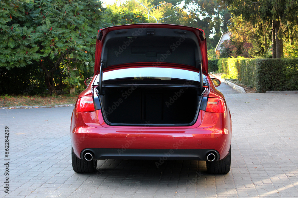 Modern red car with open empty trunk. Modern sedan car open trunk. Red ...