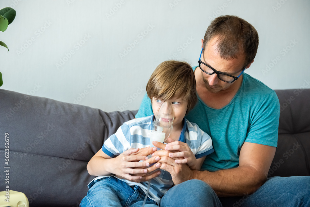Father And Son Do Inhalations Caring Dad Helps His Son Has To Breathe