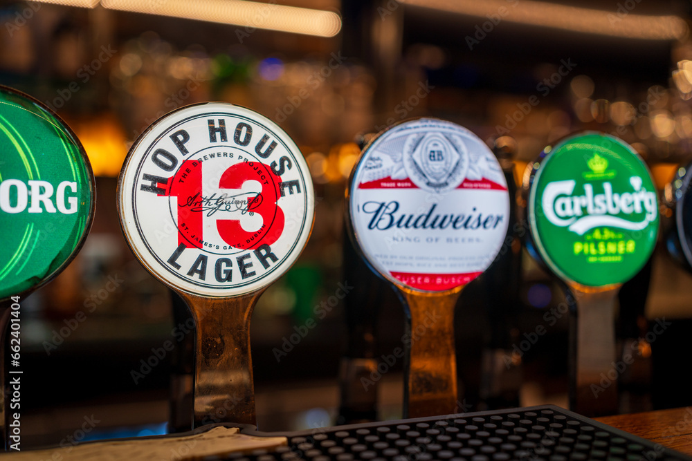 Bright label of HOP HOUSE 13 LAGER beer on a tap in a pub with bubbles ...