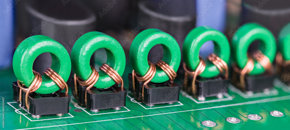 Row of toroidal transformer inductors on PCB for audio or video signal ...